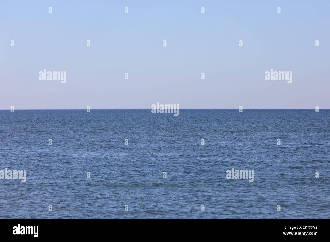 simple background of the sea with blue sky with no boats and no people ...