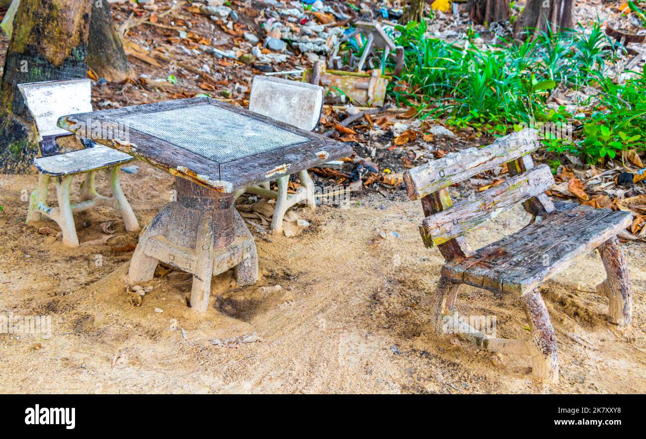 Old dirty rotten bench table with chairs in forest in Naithon Beach ...
