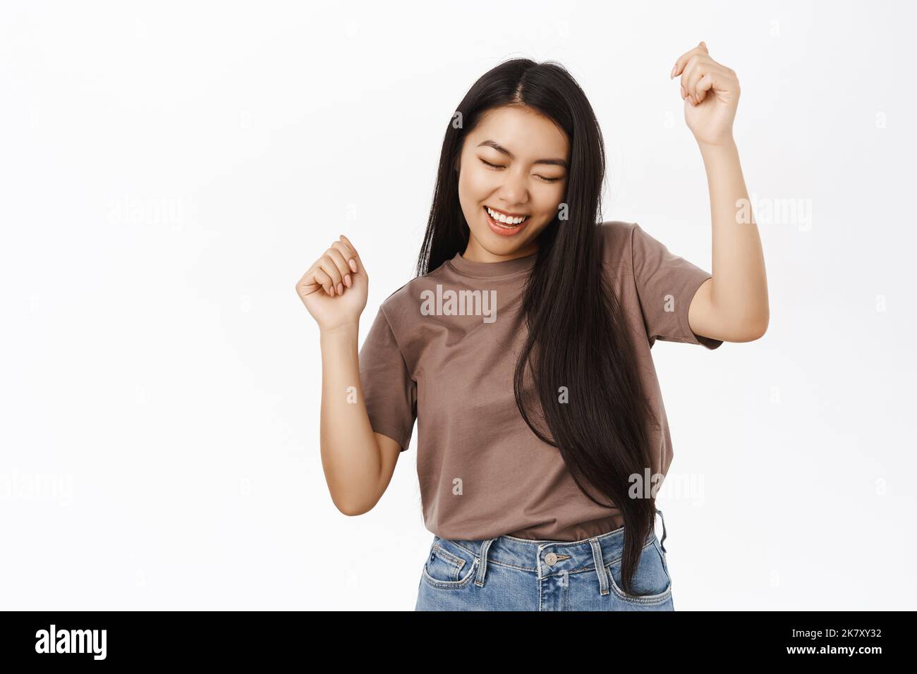 Happy dancing asian girl, celebrating and triumphing, winning and ...