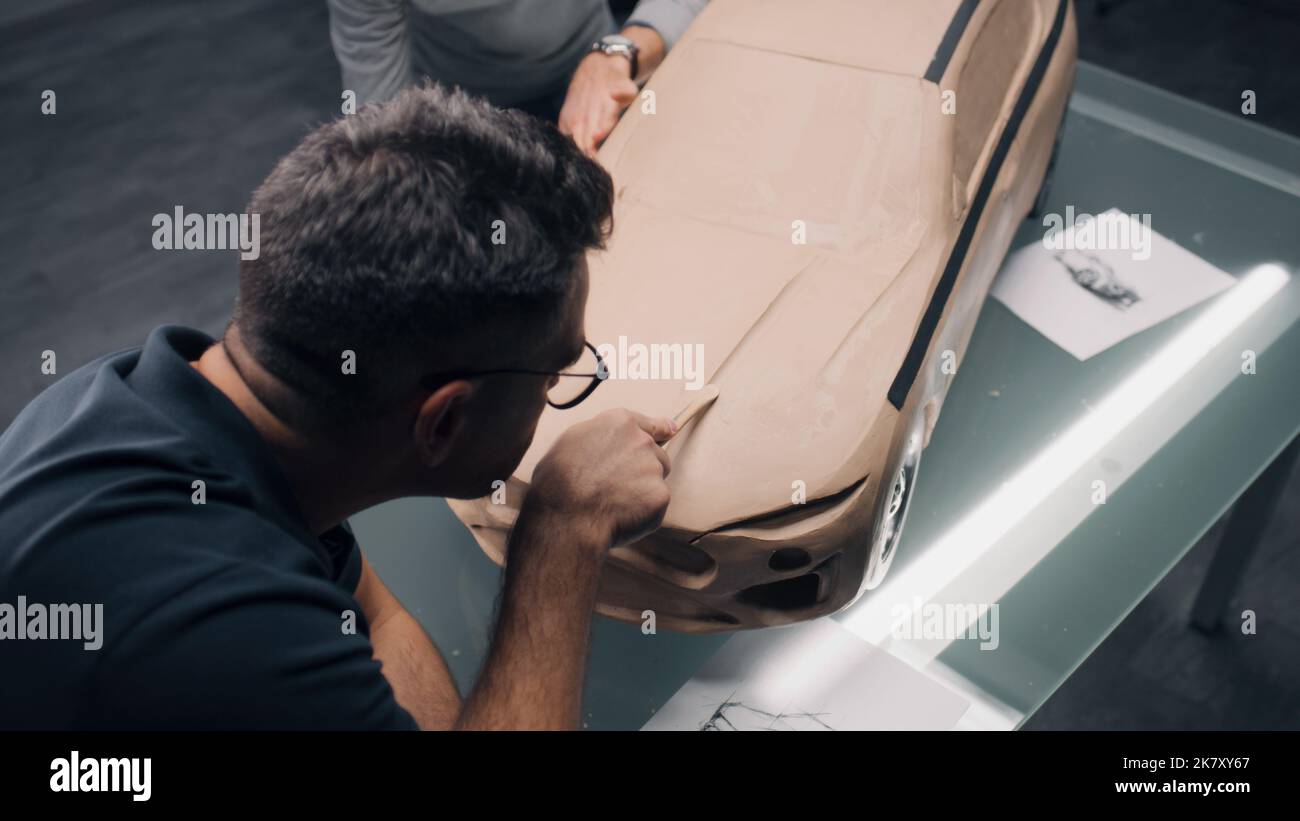 High angle shot of two male automotive designers working on eco ...