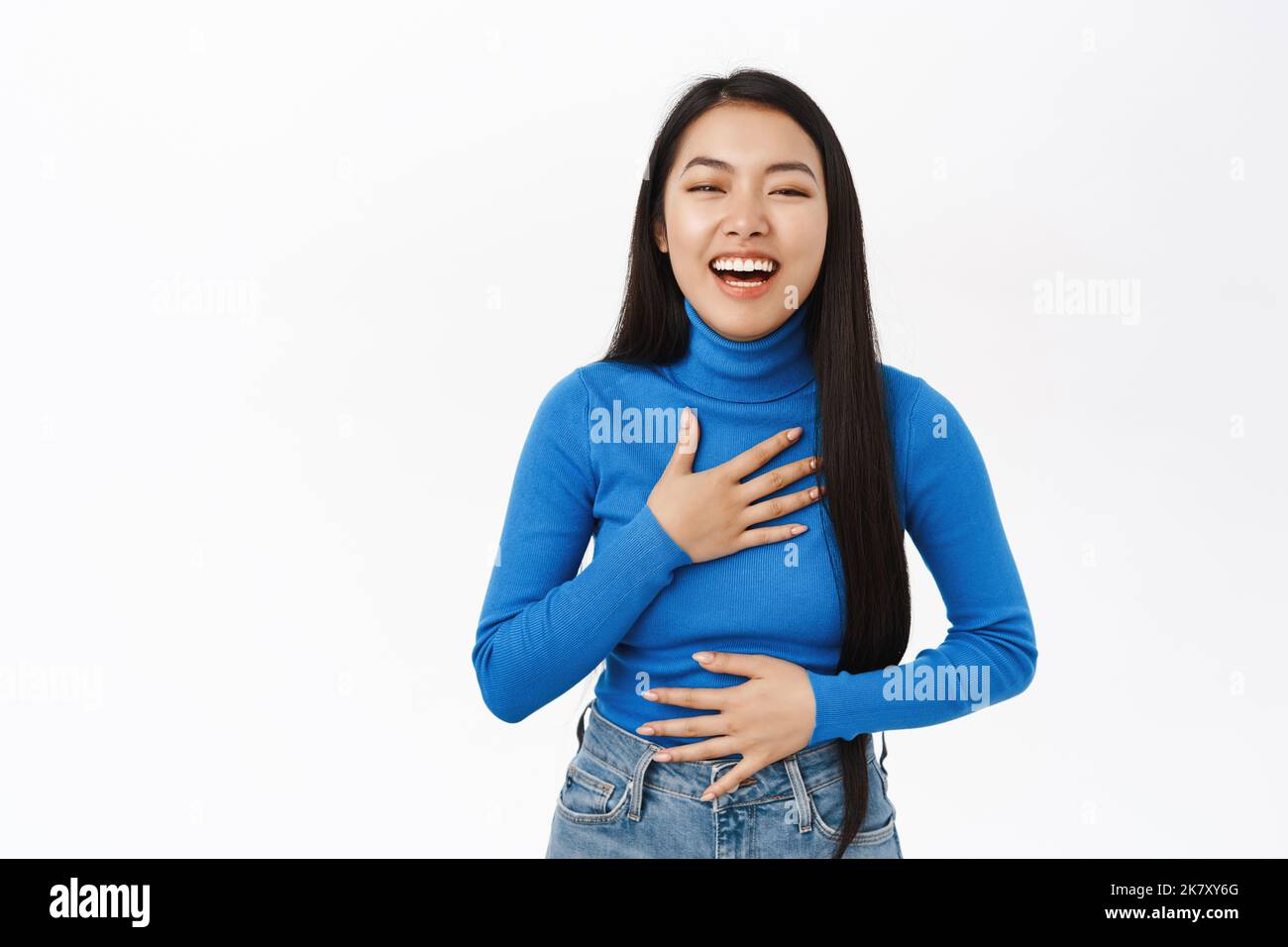 Portrait of laughing asian girl smile, chuckle, looking at smth funny ...