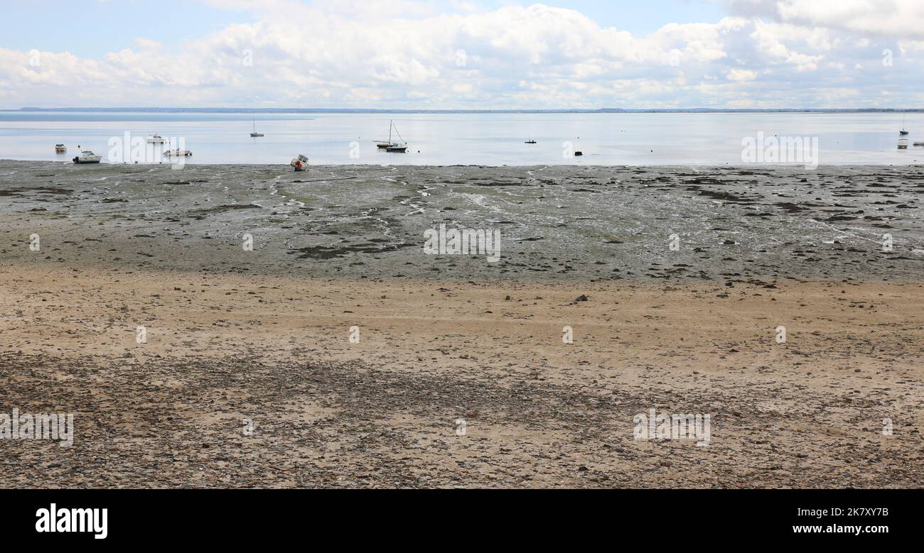 beached boats stranded on muddy sand at low tide Stock Photo - Alamy