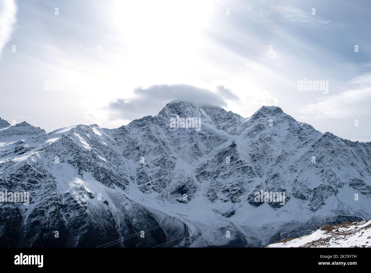 View of the mountain range, steep slopes and snow-capped rocky peaks ...
