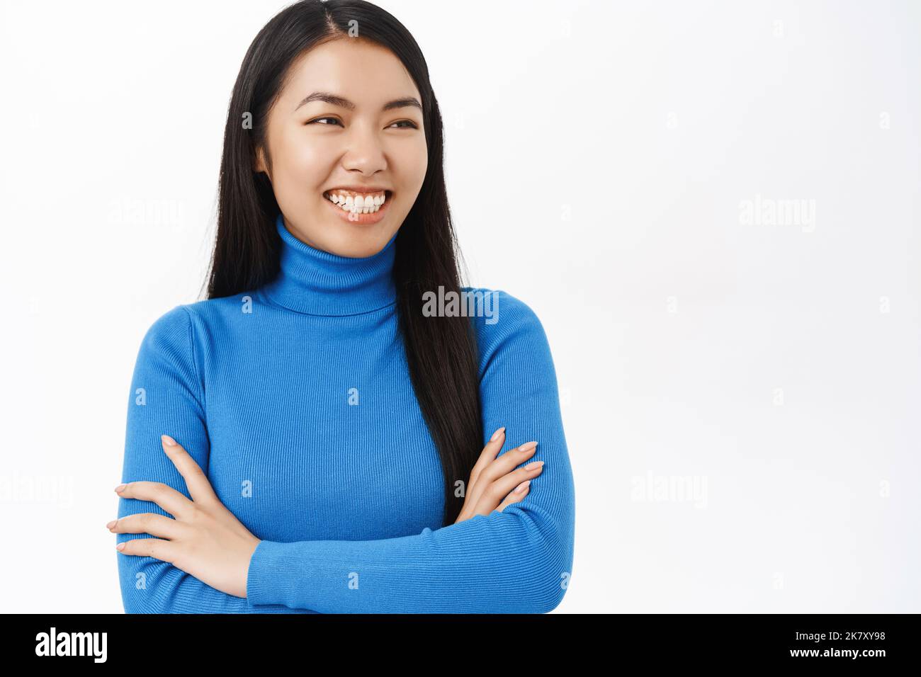 Confidence. Smiling young asian woman in power pose, cross arms on ...