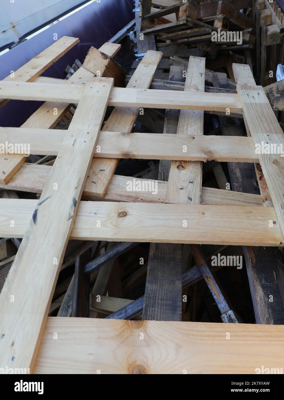 used broken wooden pallets inside the recycling container of used ...