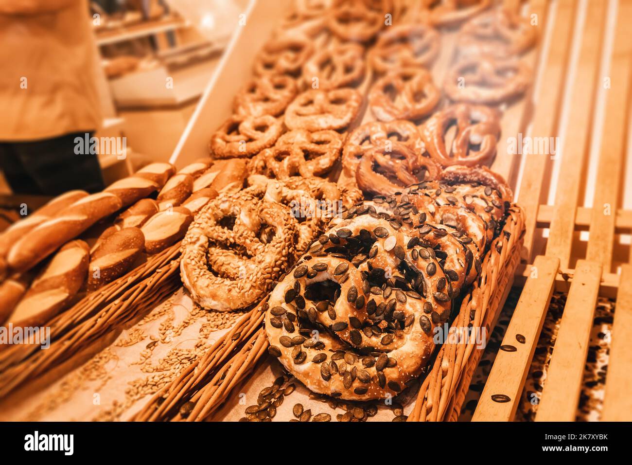Assortment of pretzel and bagel buns on a showcase counter at bakery ...