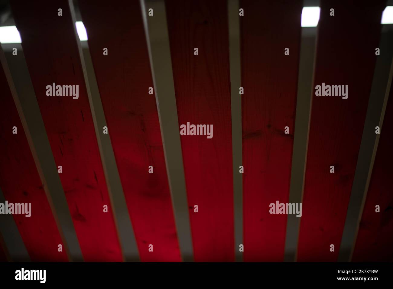 Boards in red light. Neon light on boards. Warehouse of building ...