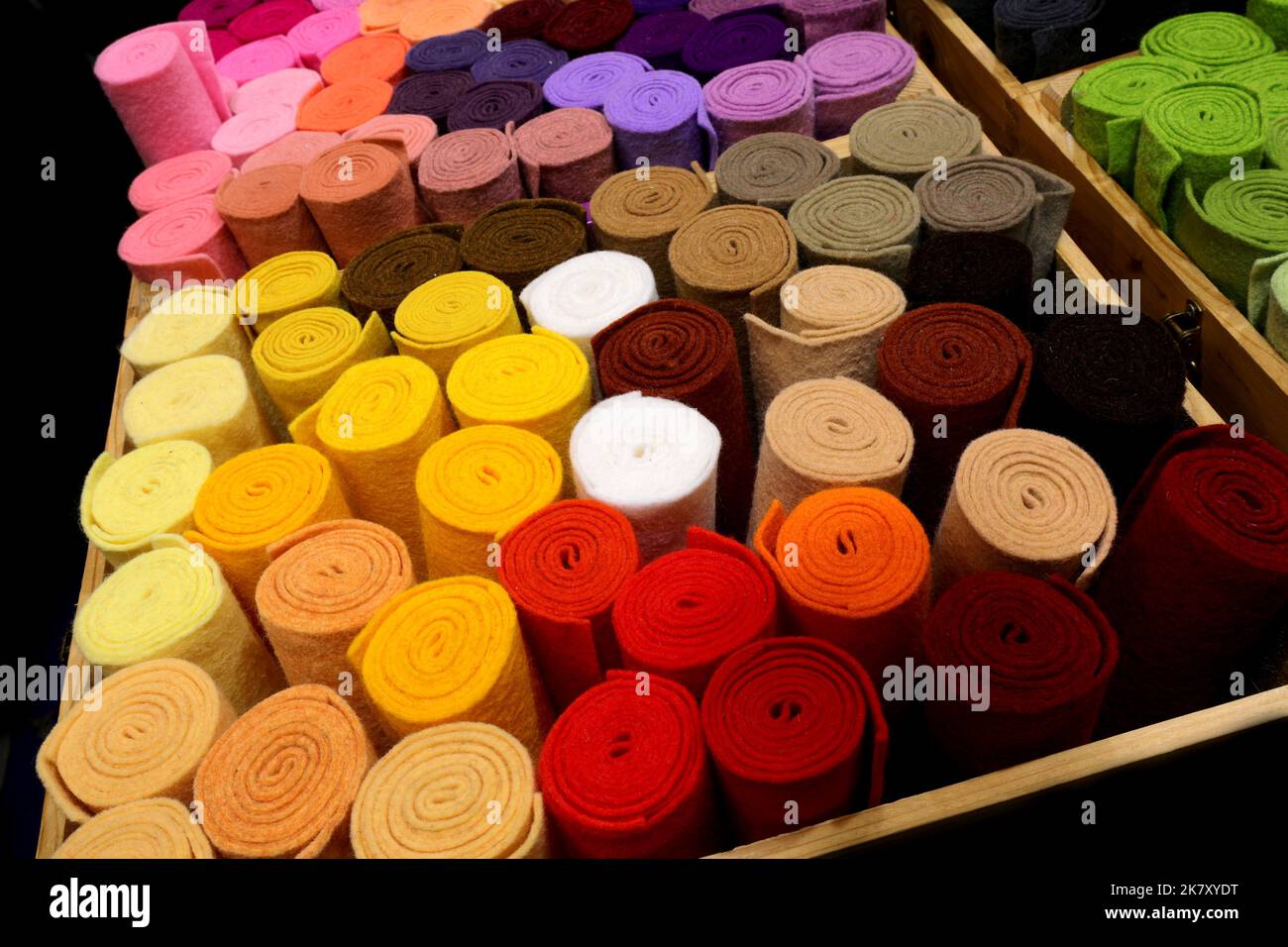 tubes of fabrics and colorful cloths and for sale in the cloth shop ...