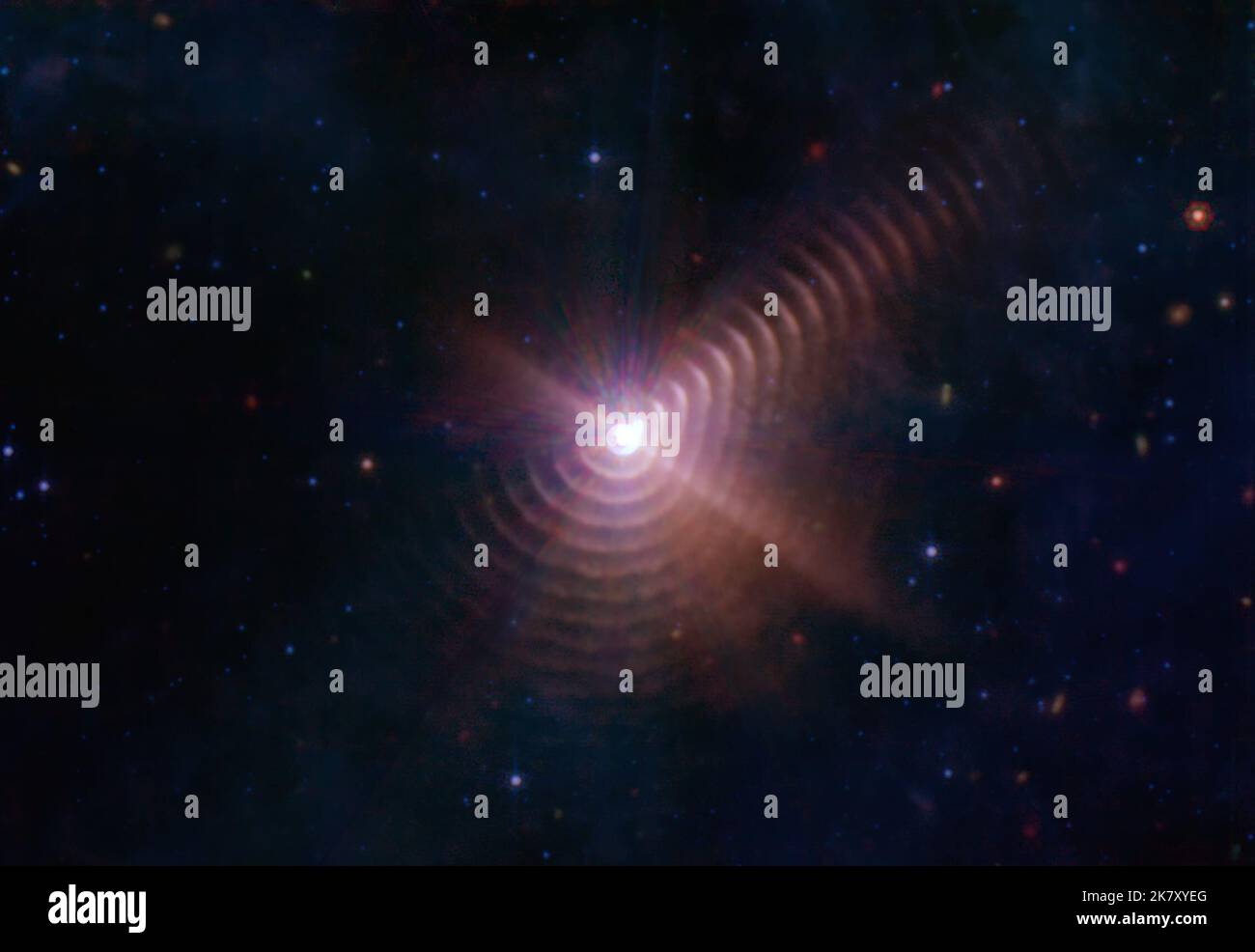 Shells of cosmic dust created by the interaction of binary stars appear ...