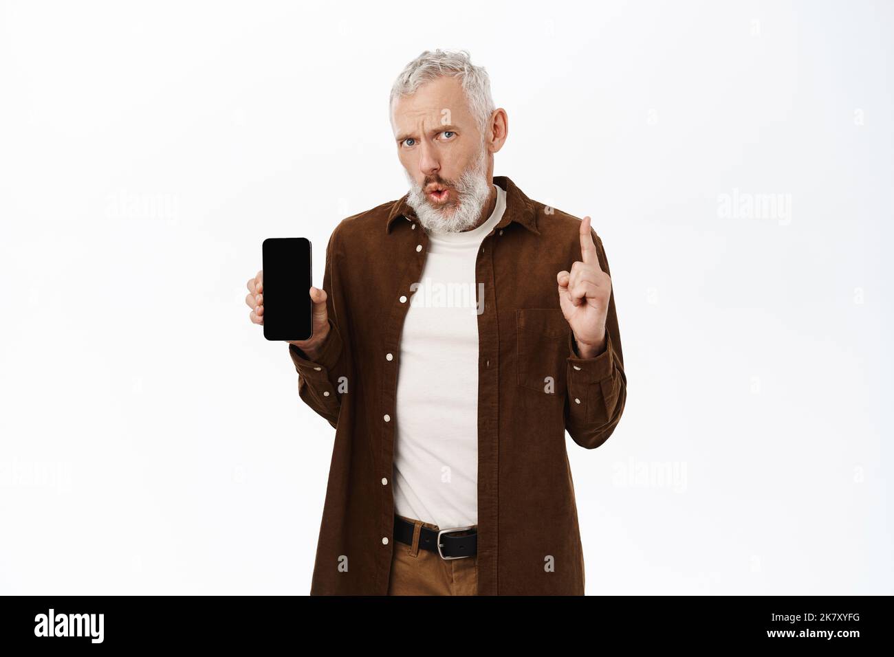 Portrait of senior man, old caucasian guy showing mobile phone screen ...