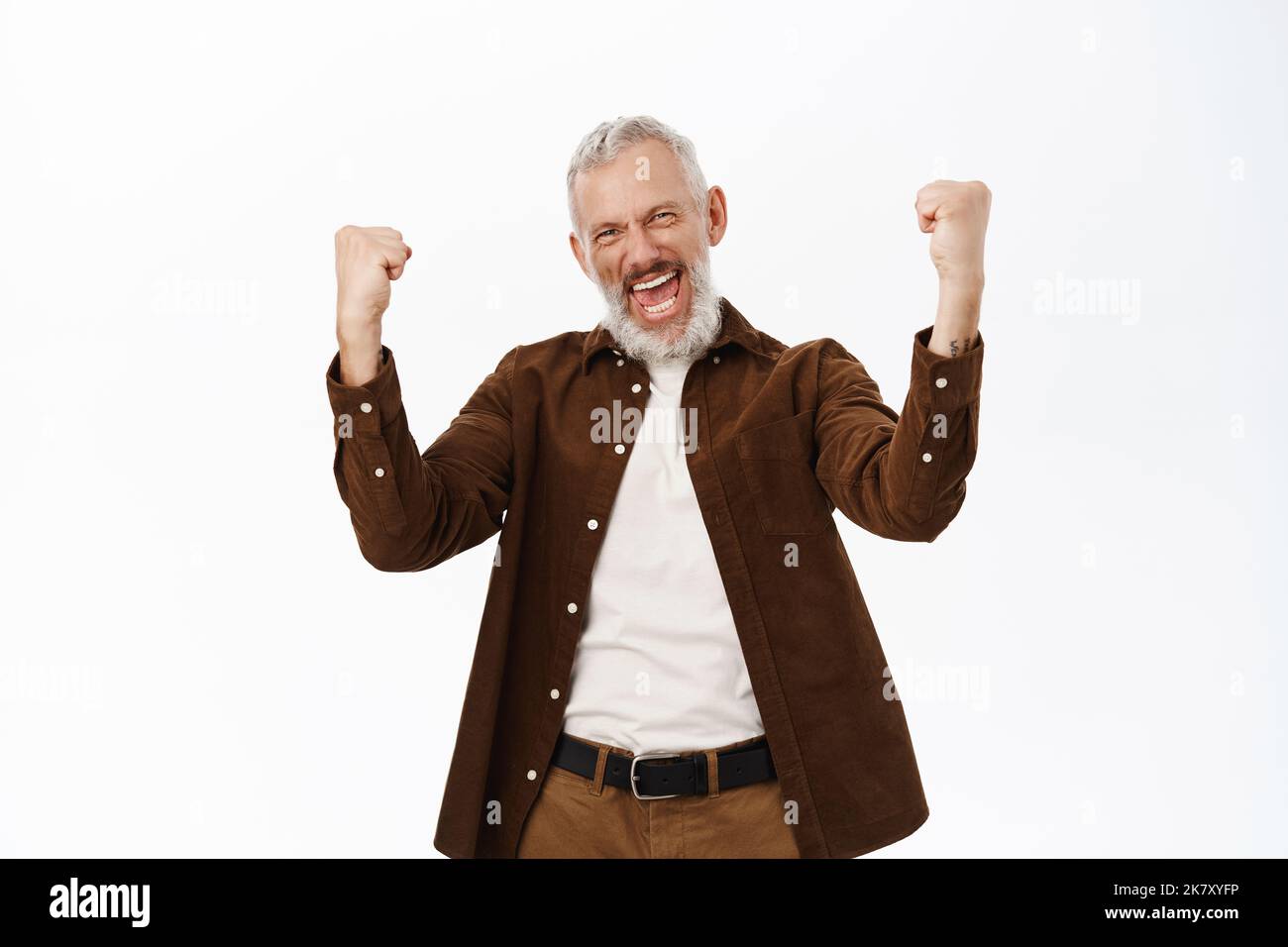 Enthusiastic old man, senior guy celebrating and triumphing, winning ...
