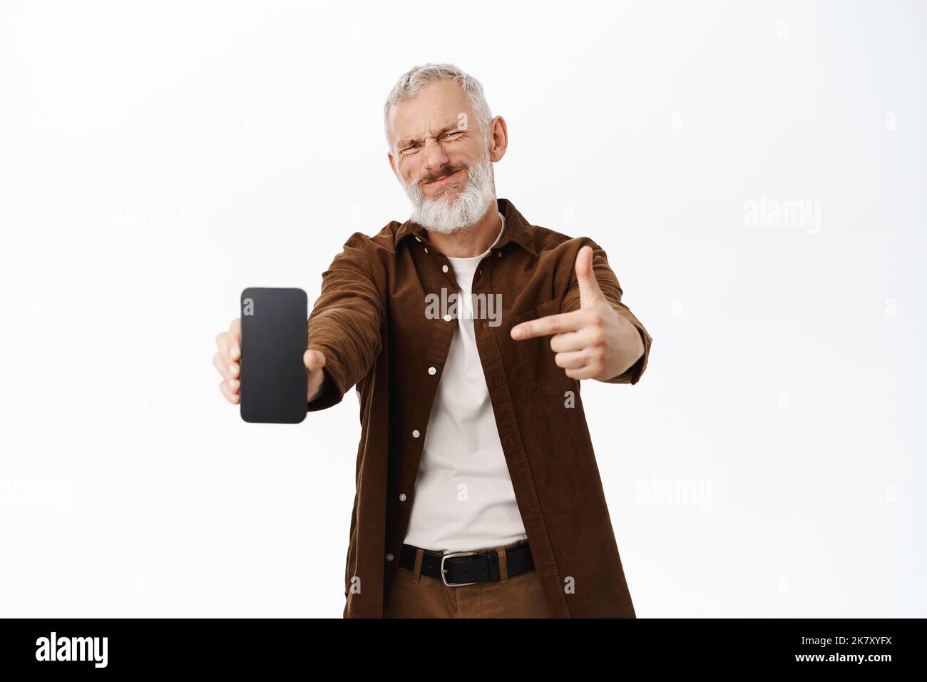 Disappointed old man, senior guy showing bad app, pointing at ...