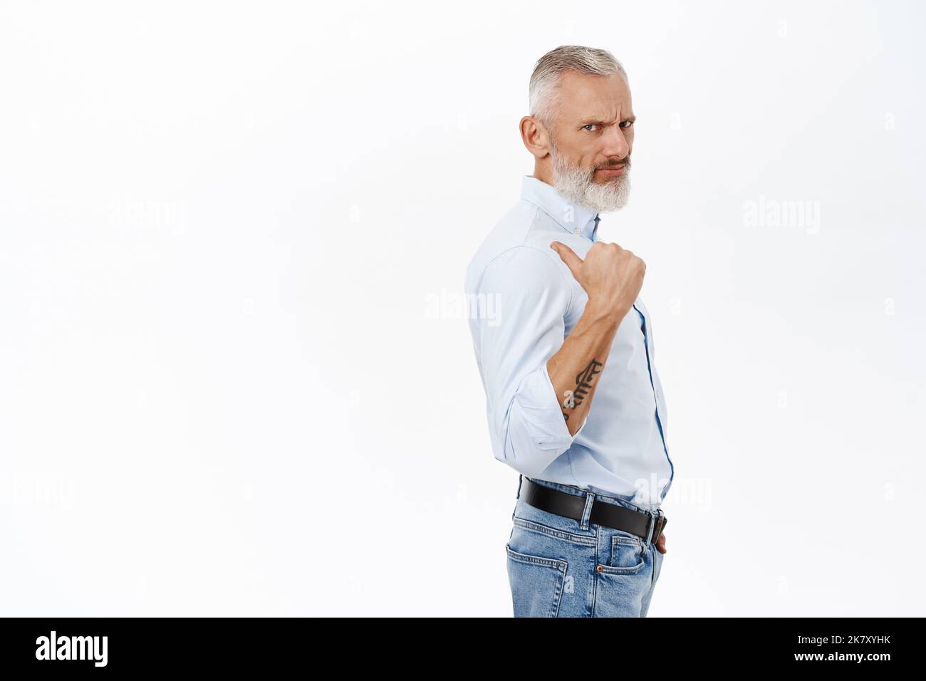Portrait of handsome mature old man, pointing finger left, behind ...