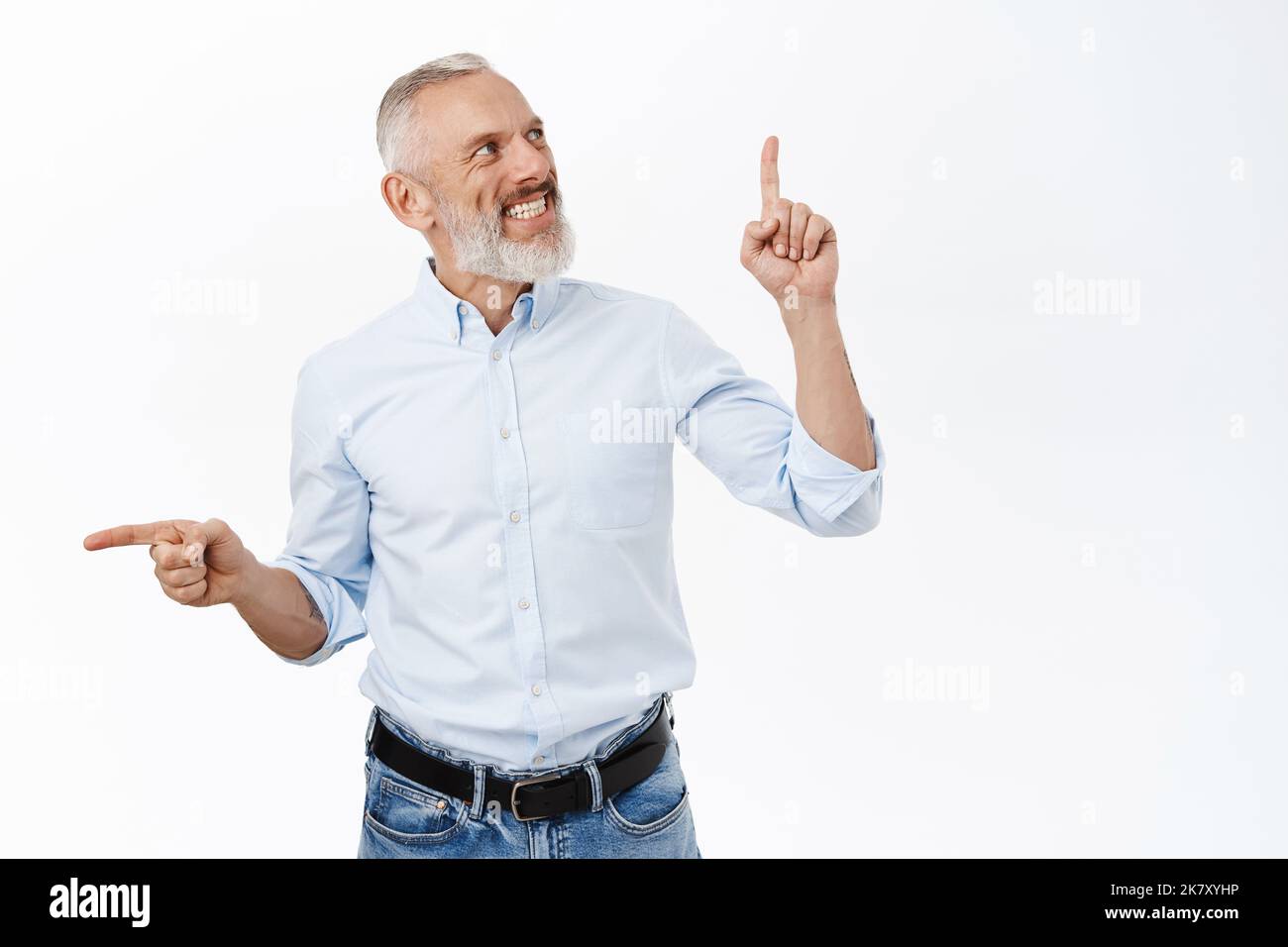 Portrait of senior business man pointing up and left, showing two ...
