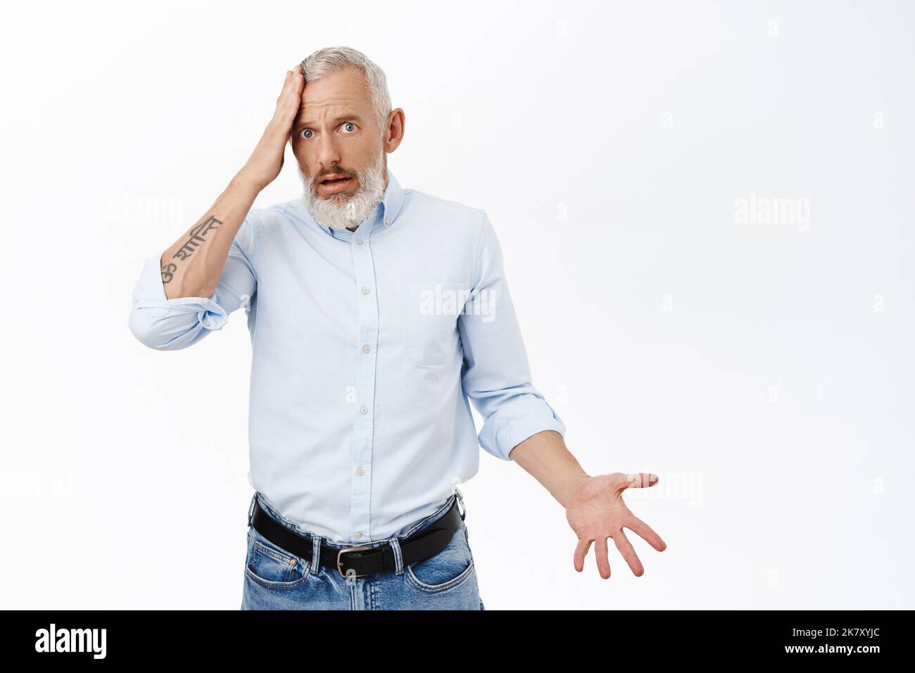 Shocked senior businessman holding hand on forehead and staring puzzled ...