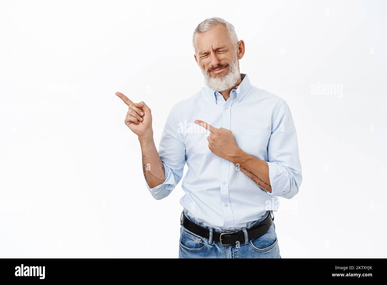 Senior business man pointing fingers left, showing advertisement, promo ...