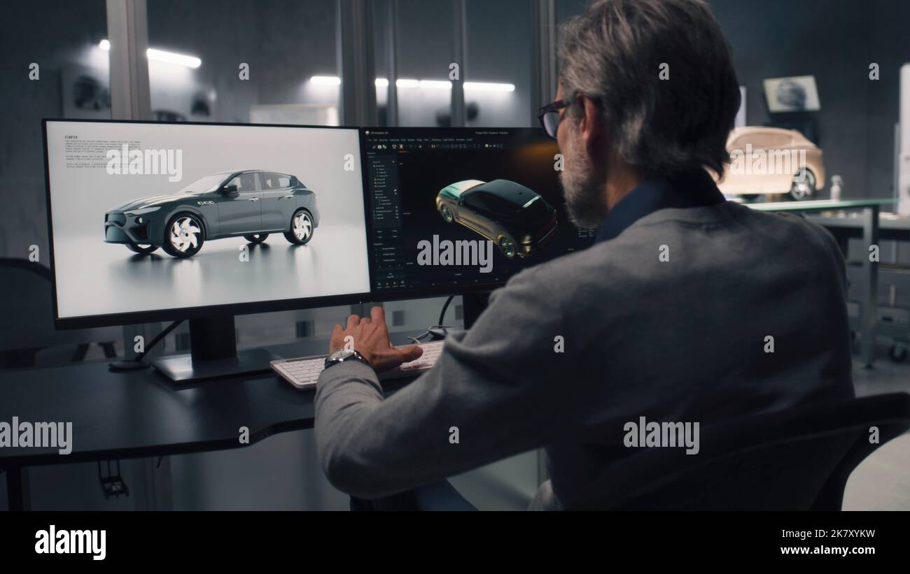 Two male automotive designers working on model of eco friendly electric ...