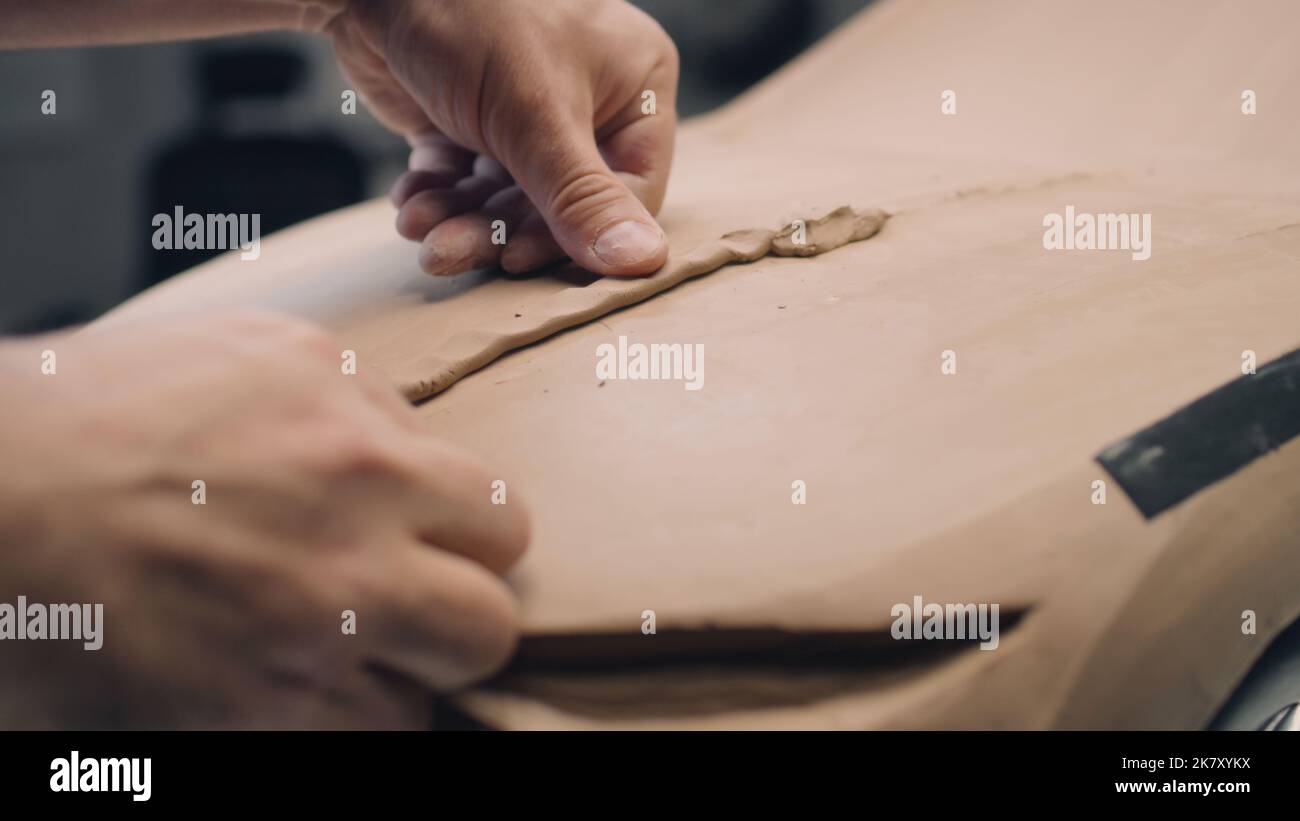 Close-up shot of male automotive designer working on futuristic car ...