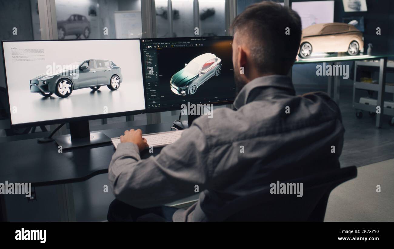 Two male automotive designers working on model of eco friendly electric ...