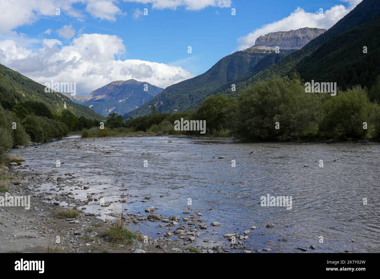 magnificent view of a river flowing through a valley sided by Spanish ...