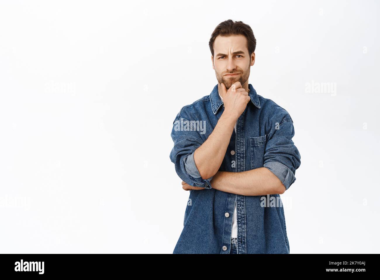 Image of adult man with skeptical gaze, looking at camera and thinking ...