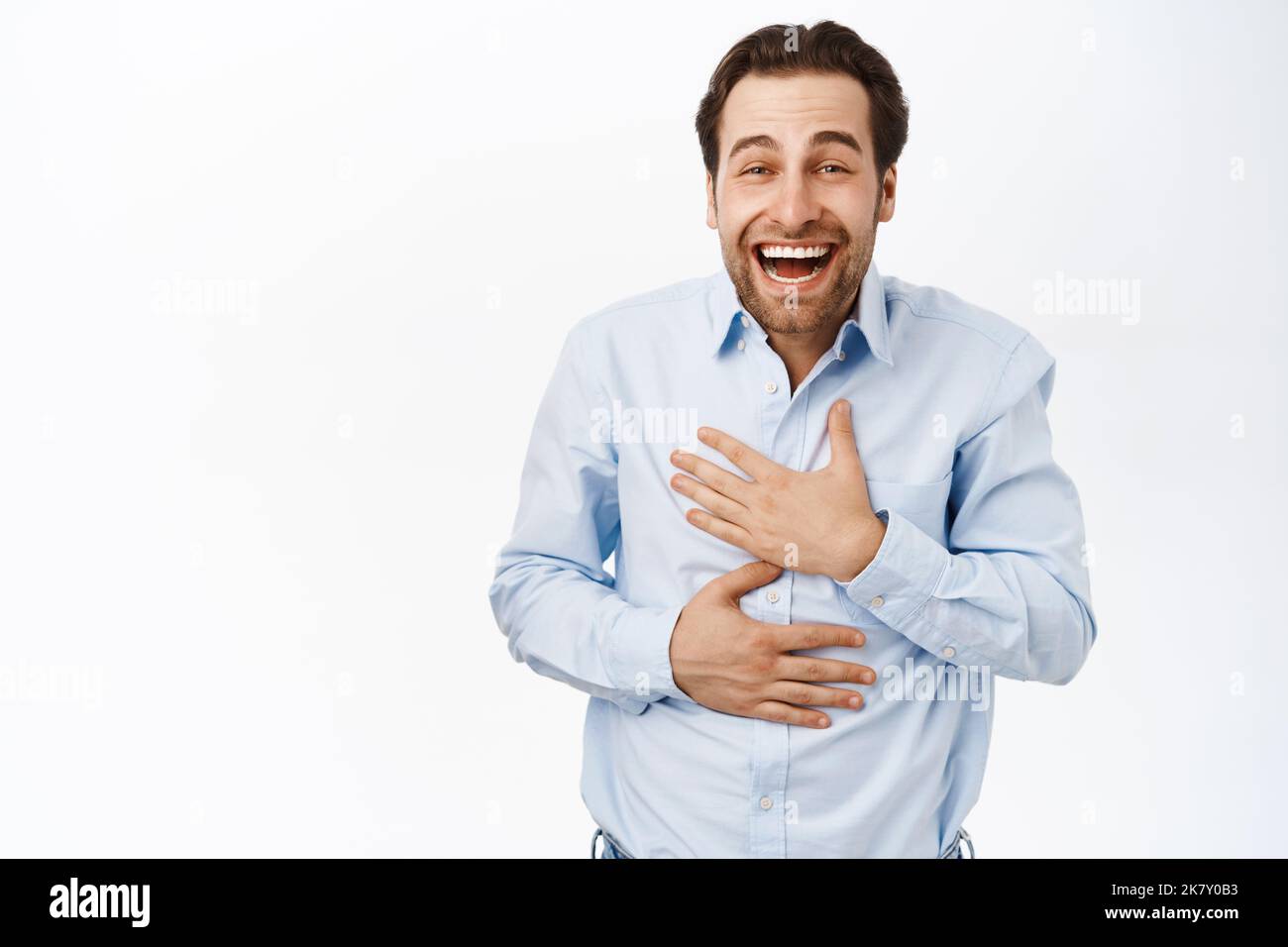 Happy office guy laughing at something really funny, chuckle and smile ...
