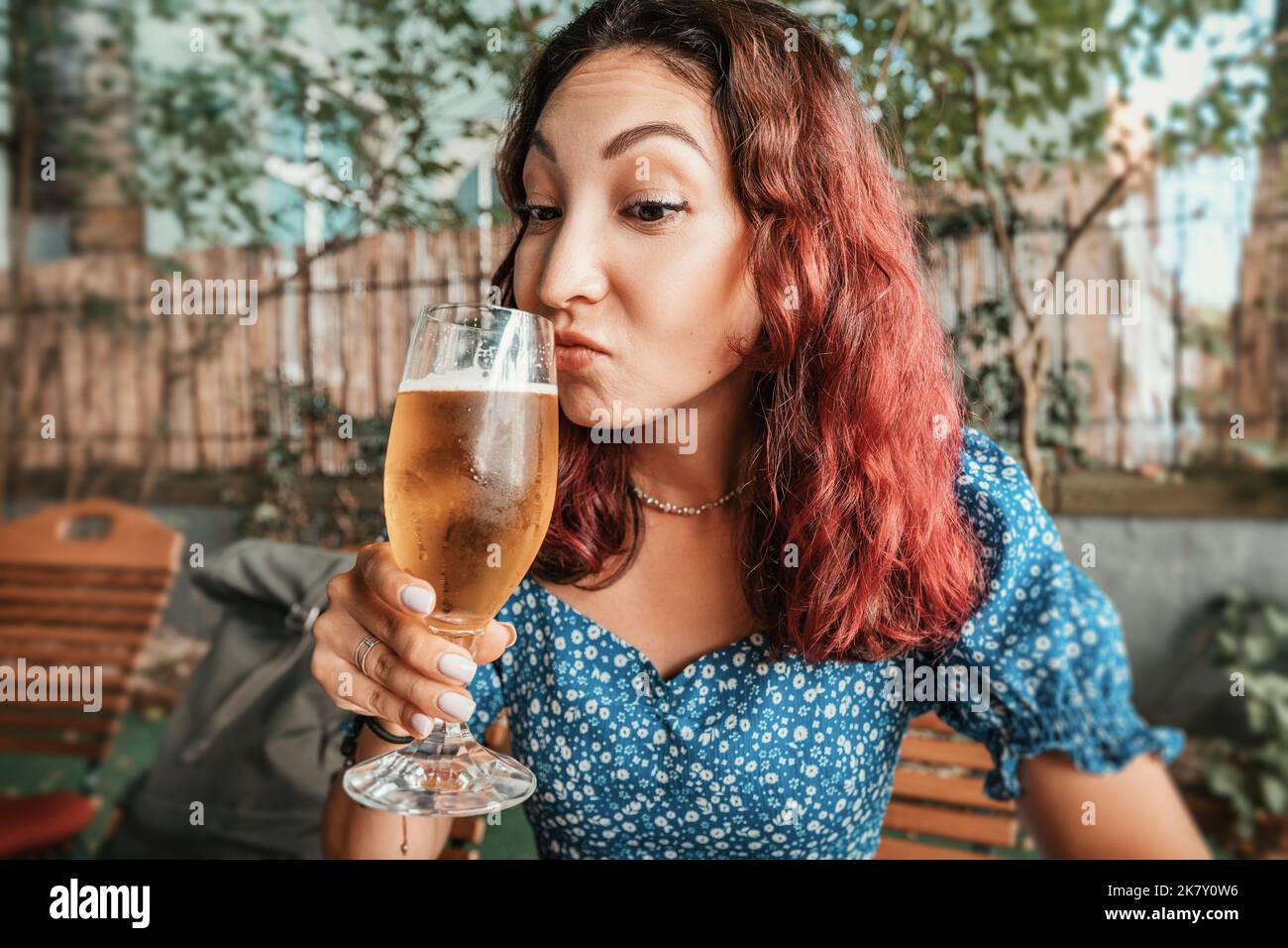 A beer sommelier girl tastes the aroma of freshly brewed malt beer at ...