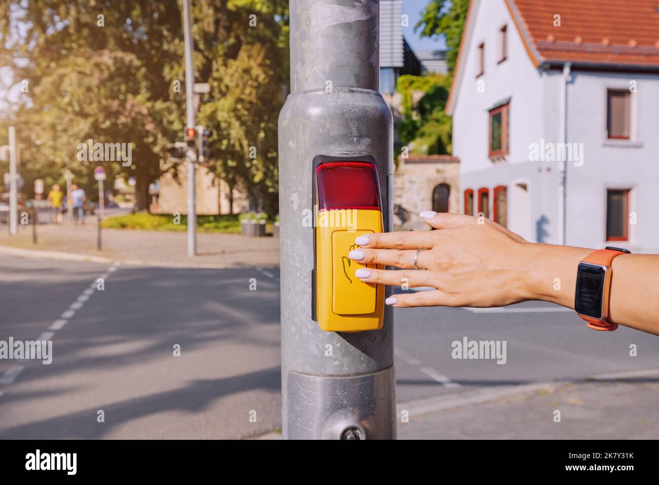 Aware passenger presses the traffic light control button to safely ...
