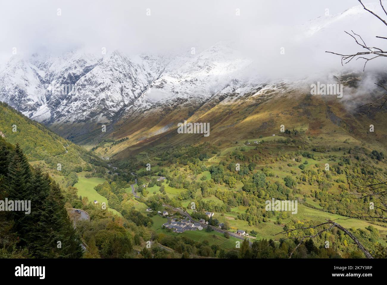 magnificent view of a long glacial valley through snow and cloud topped ...