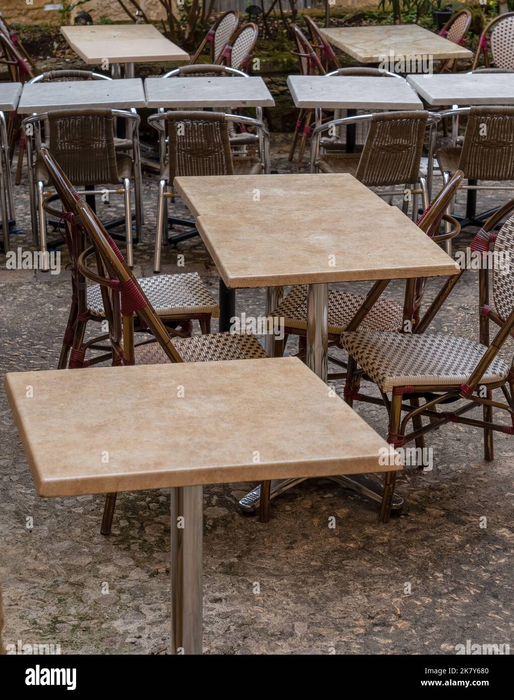 tables and chairs in a cobbled street outside a restaurant in Sarlat-la ...
