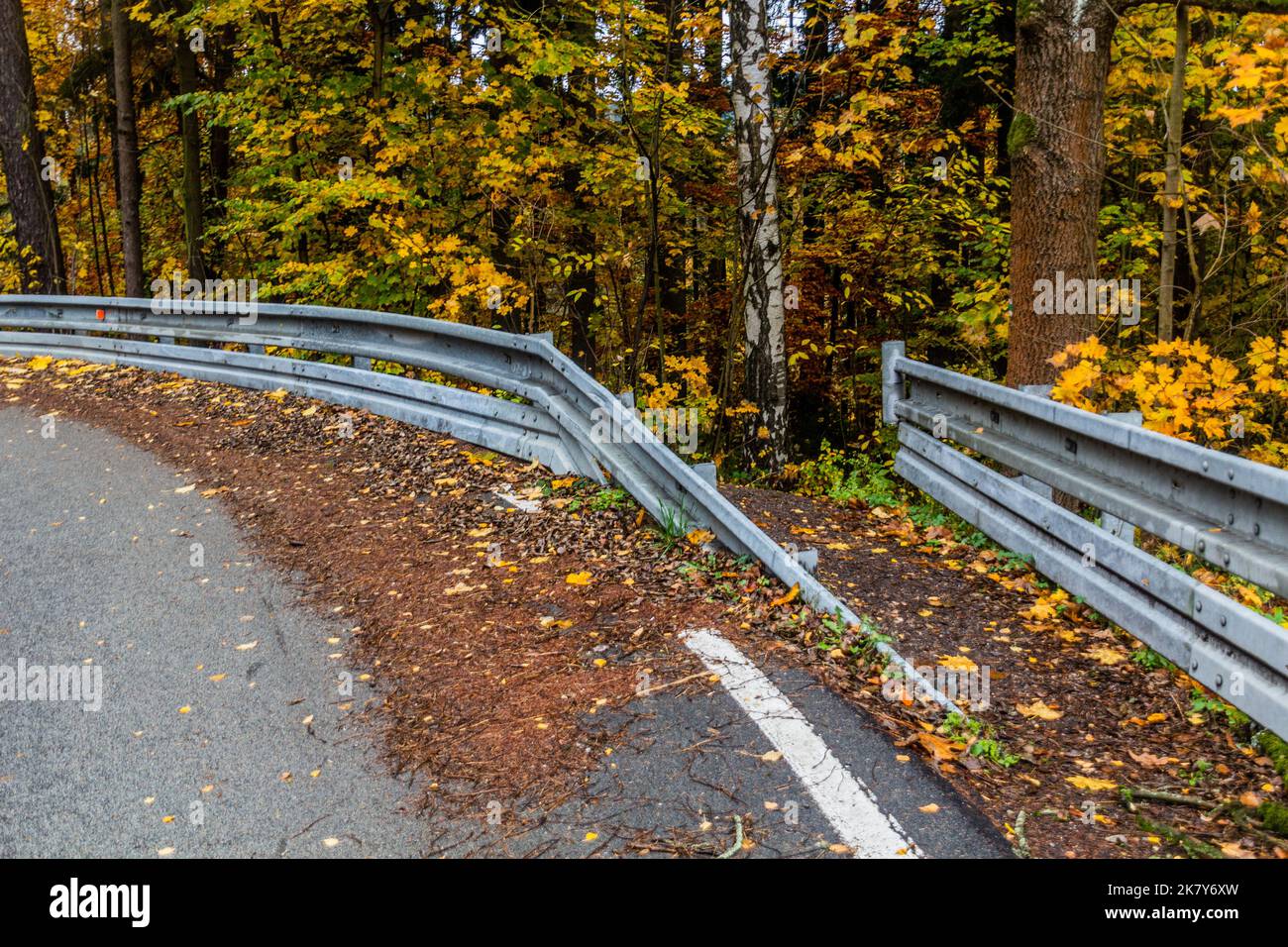Empty space in a crash barrier for a path Stock Photo - Alamy