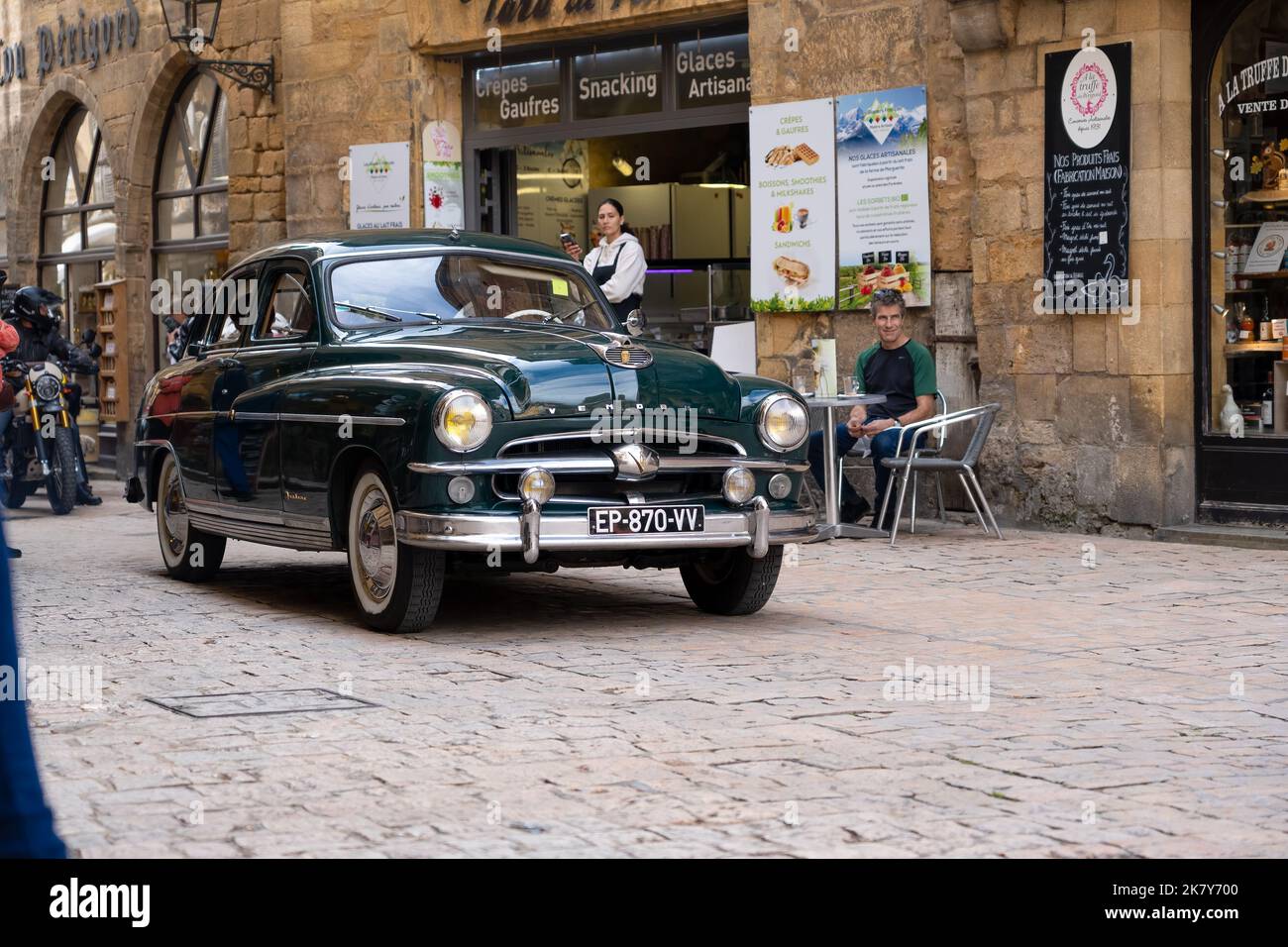 A 1954 classic concours Ford Vendome entering the Sarlat-la-Caneda town ...