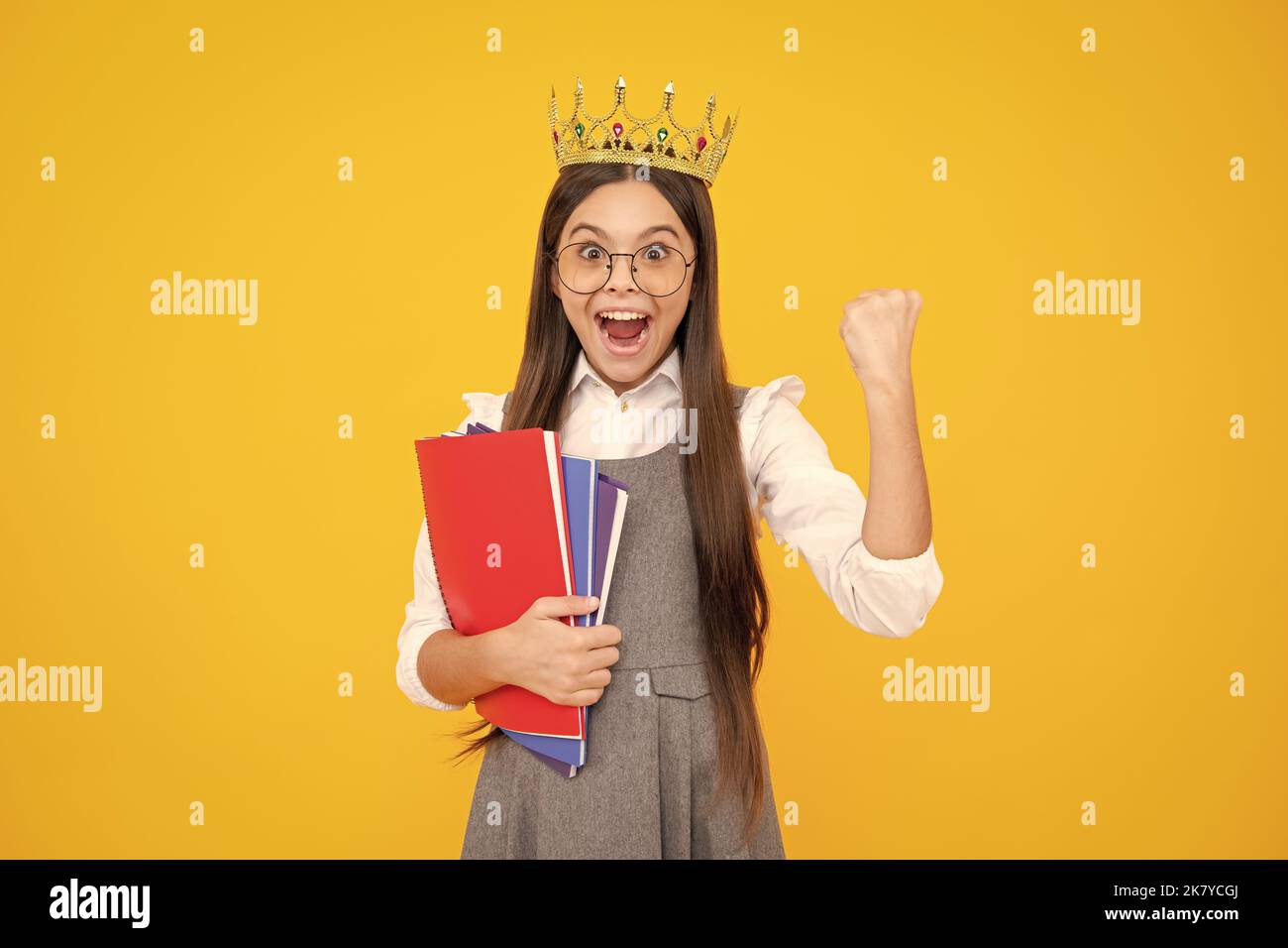 Excited face. Schoolgirl in school uniform and crown celebrating ...