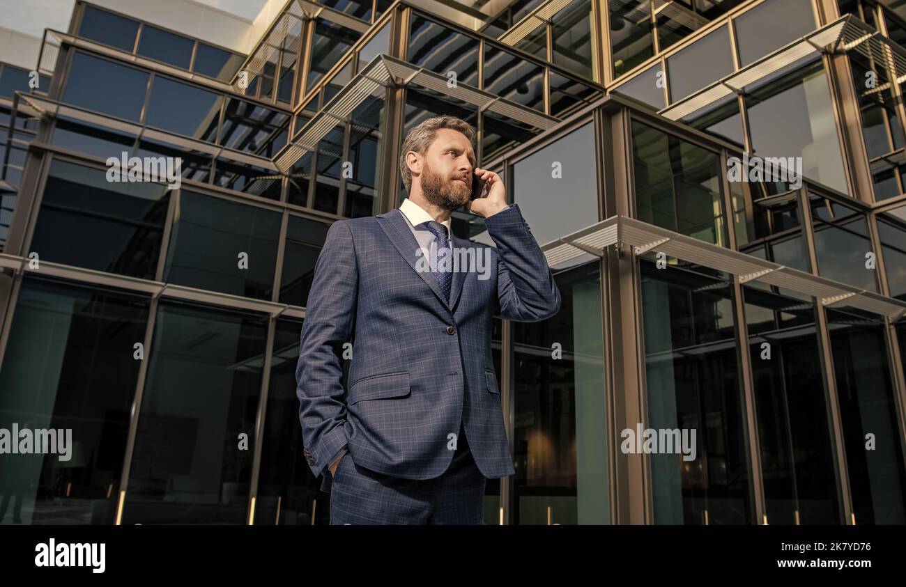 charismatic entrepreneur in suit has phone conversation outside the ...