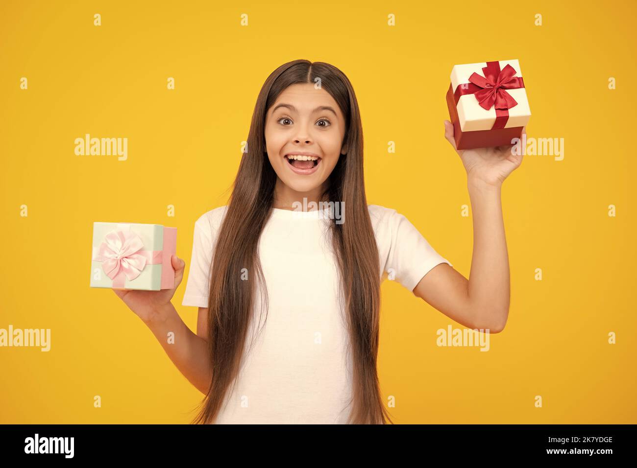 Excited teenager, glad amazed and overjoyed emotions. Child teen girl 12-14 years old with gift ...