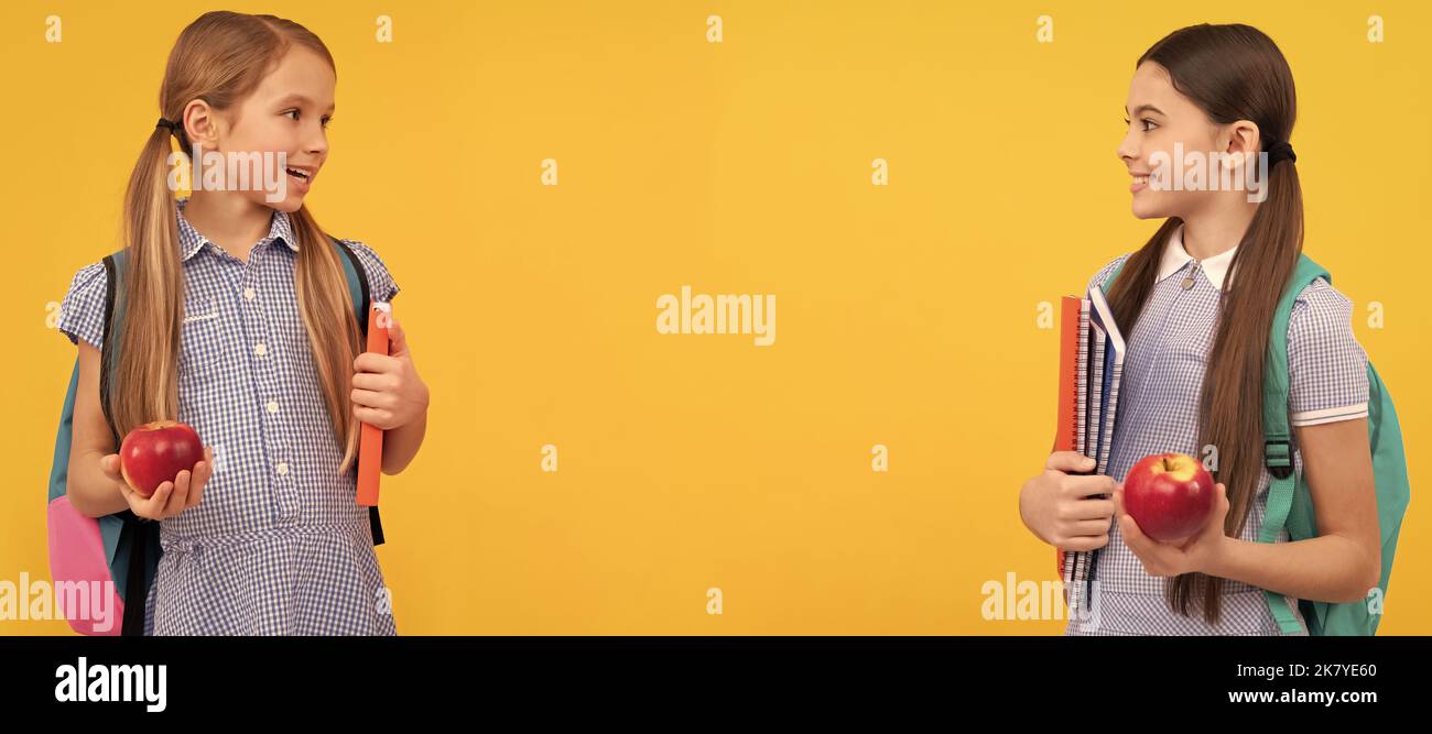 School girls friends. Happy children friends back to school holding ...