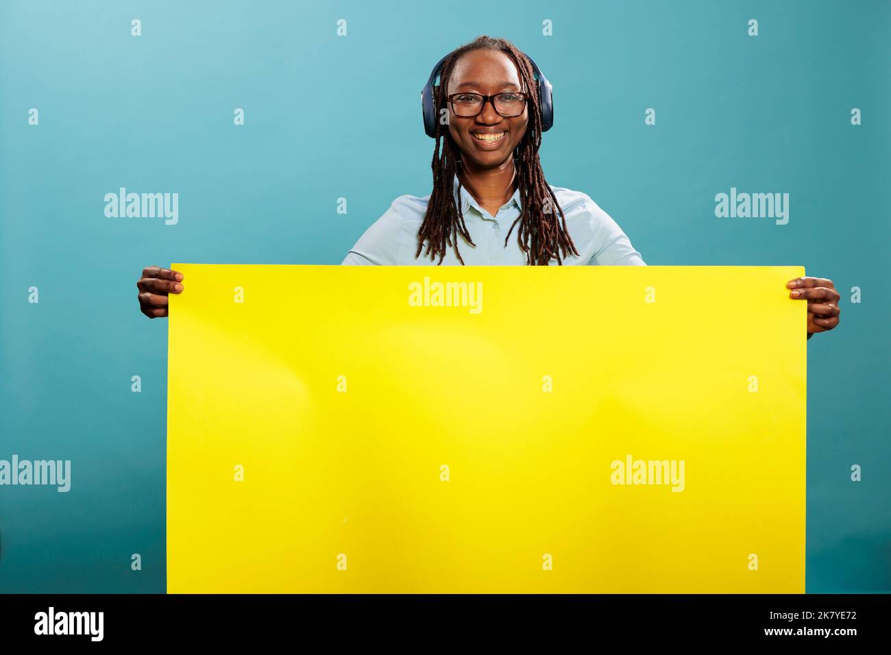 Confident young adult person with electronic earphones and empty ...