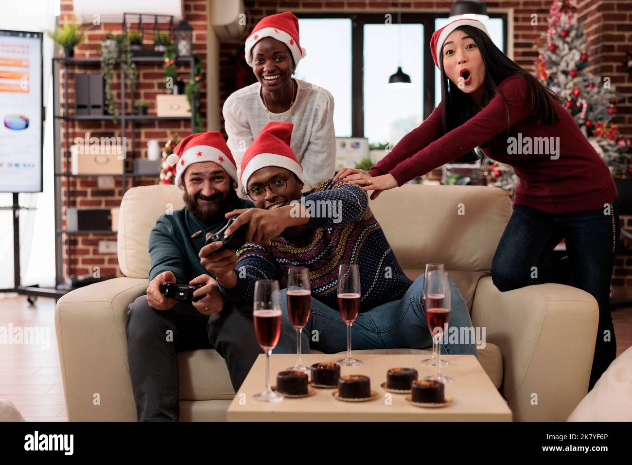 Festive work colleagues playing online video games to celebrate ...