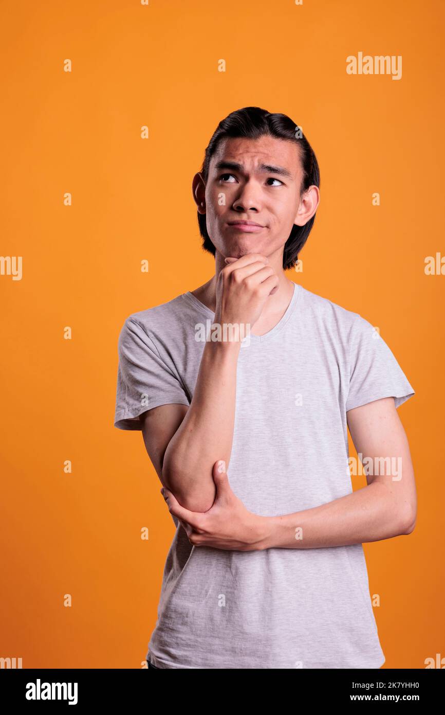 Pensive asian man touching hi-res stock photography and images - Alamy