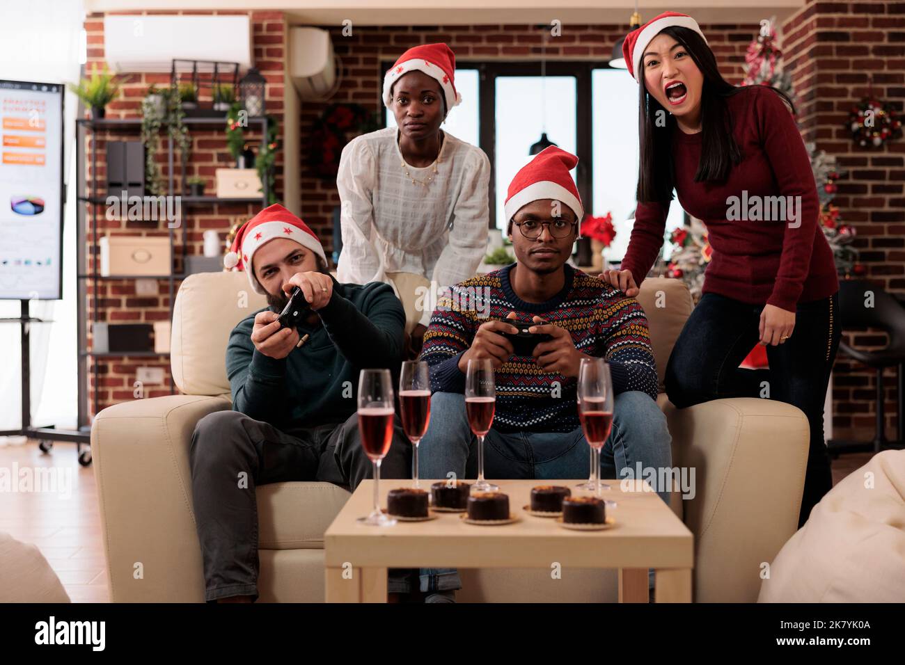 Festive coworkers playing online video games to celebrate christmas eve ...
