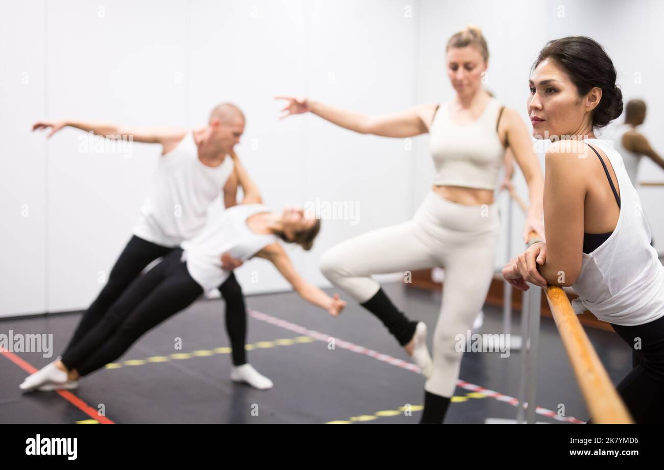 Female ballet dancer resting after rehearsal in dance hall Stock Photo ...
