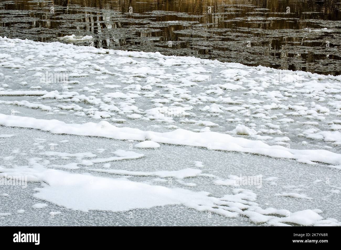 Ice and Snow Patterns contrast with Forest Reflections in this abstract ...