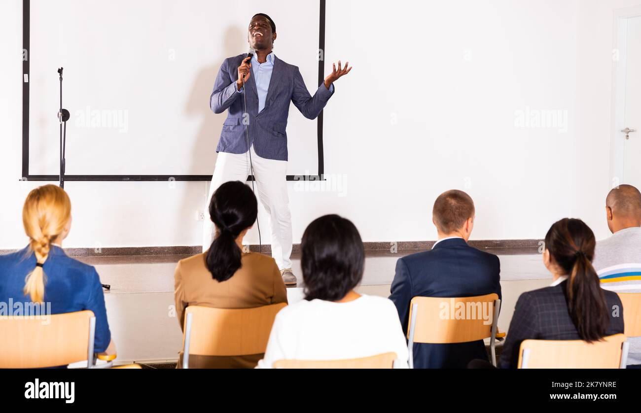 Young emotional male coach giving motivational speech Stock Photo - Alamy