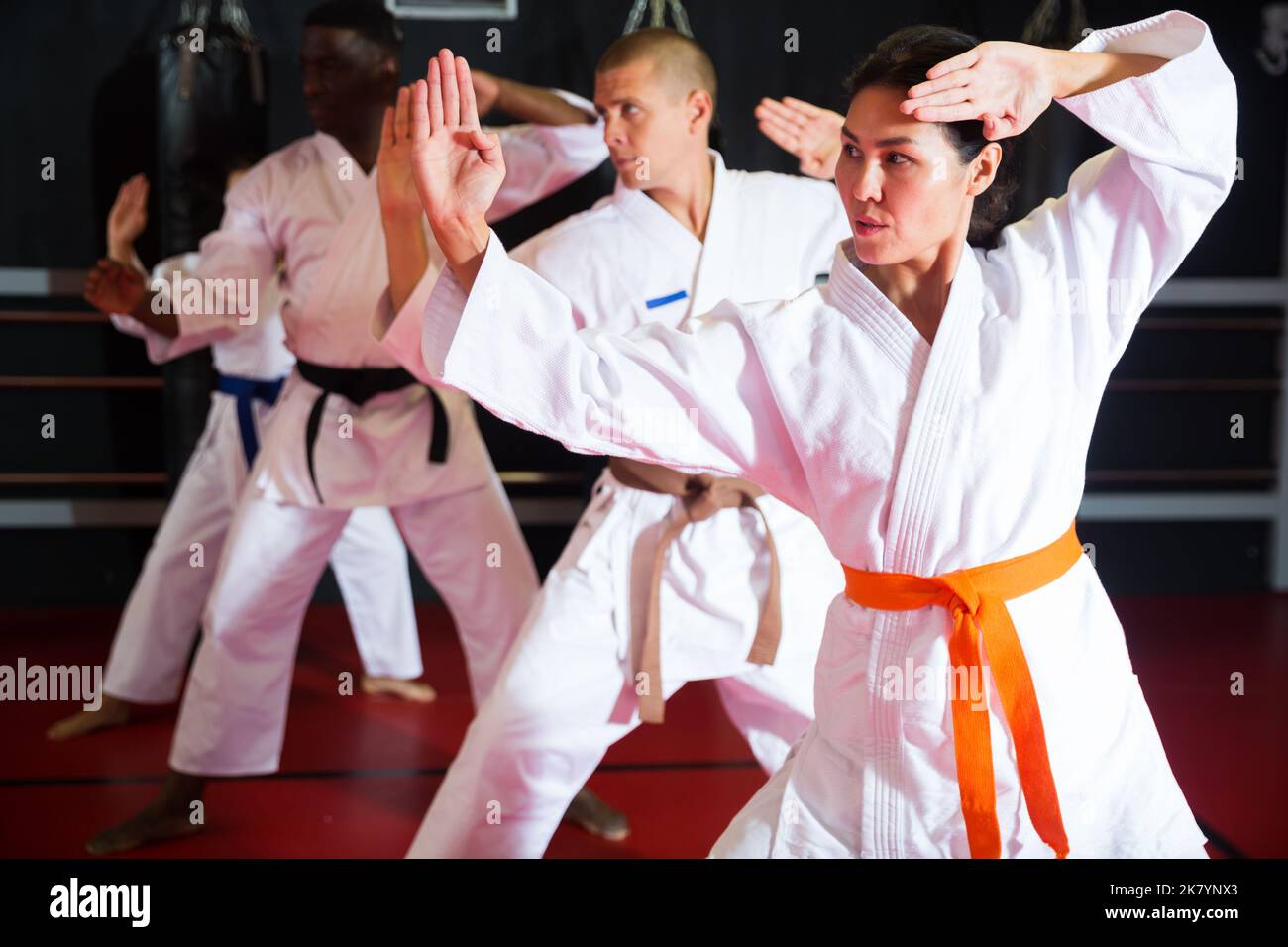 Karate or taekwondo training - athletes in kimono stand in fighting ...