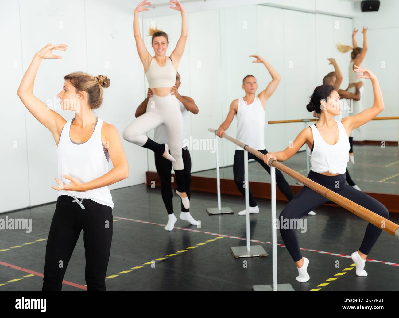 Lesson in ballet school - men and women perform ballet exercises Stock ...