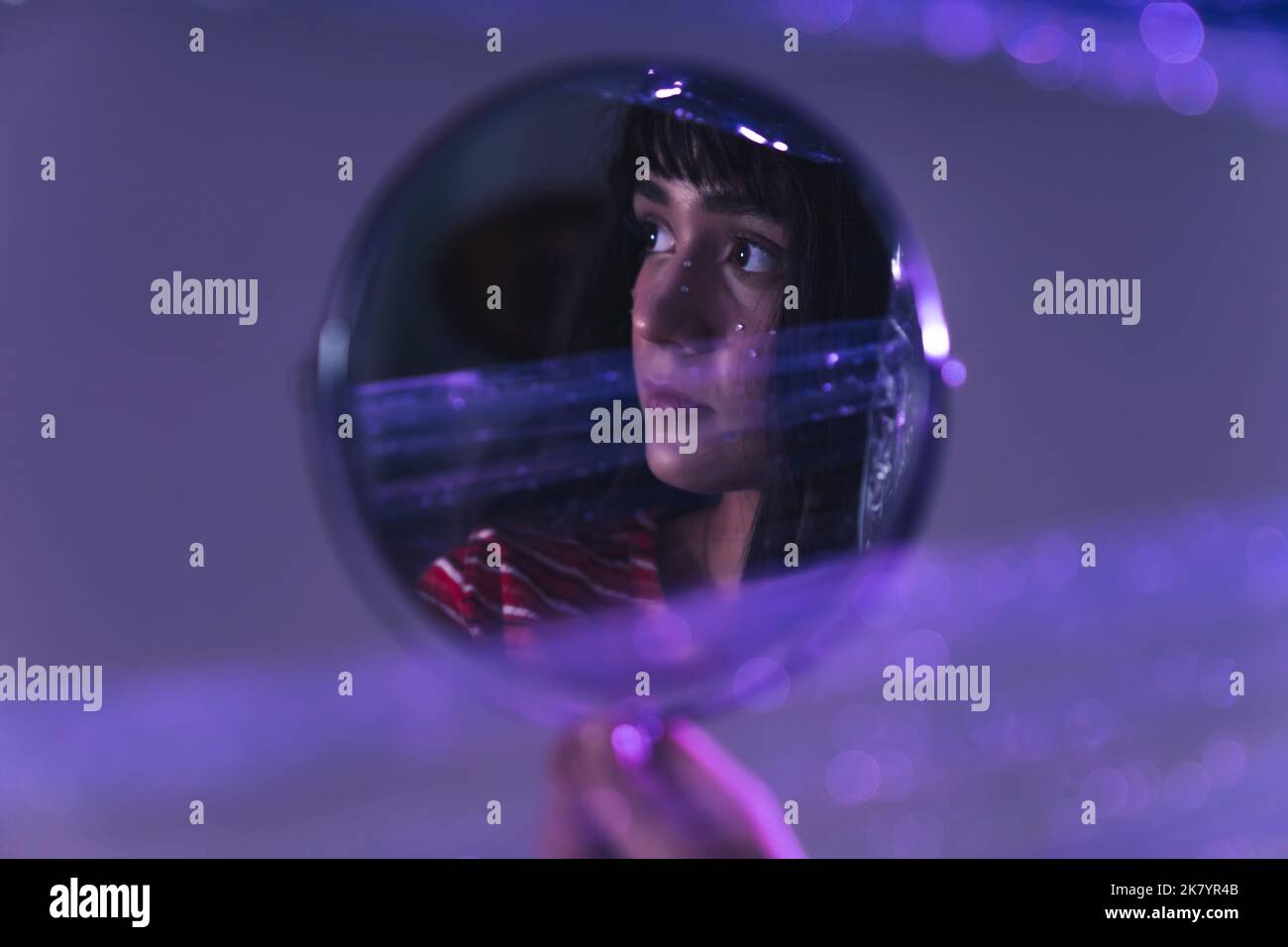 Woman looking through hair in mirror hi-res stock photography and ...