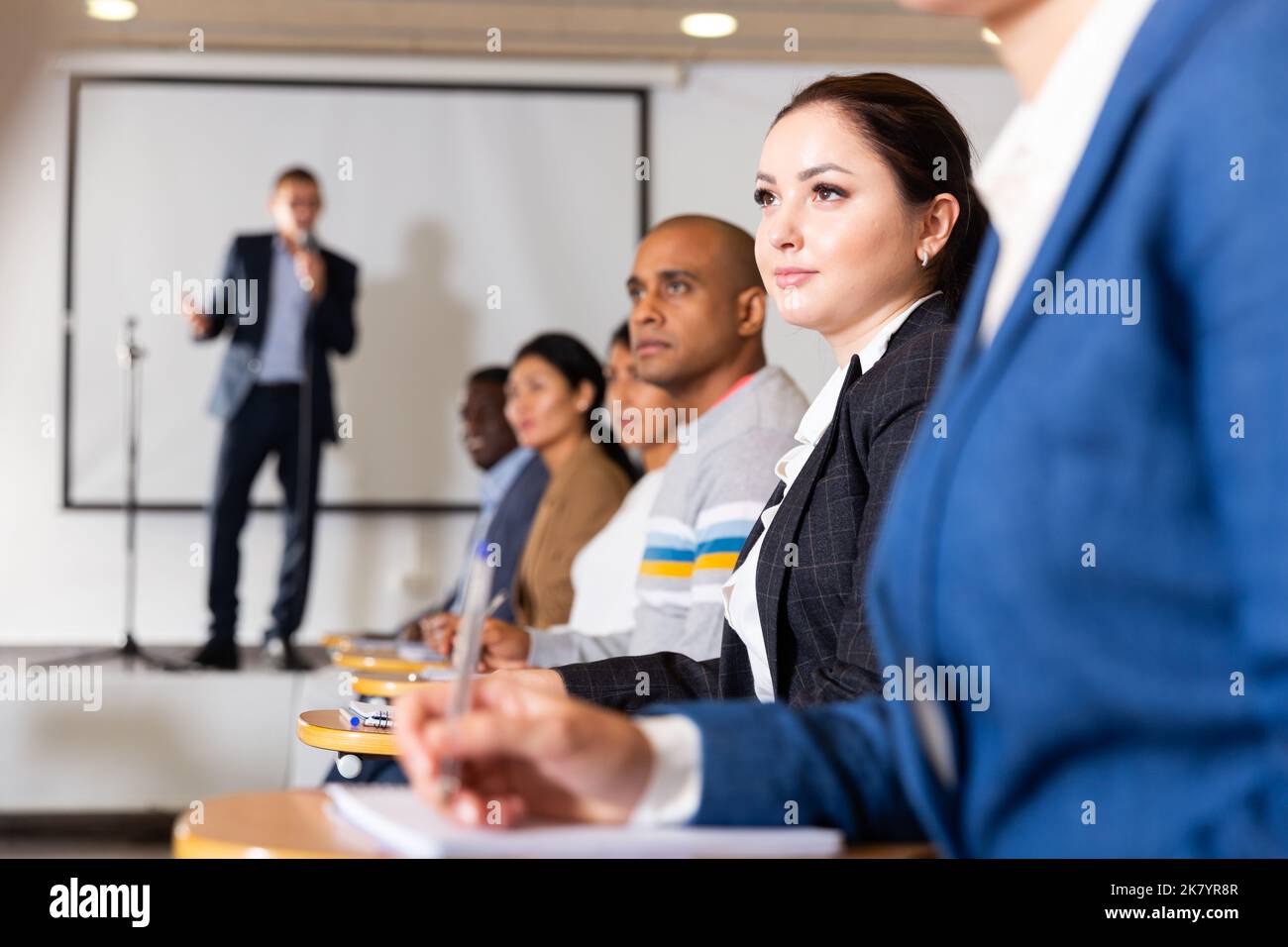 Female entrepreneur sitting in conference room at business training ...