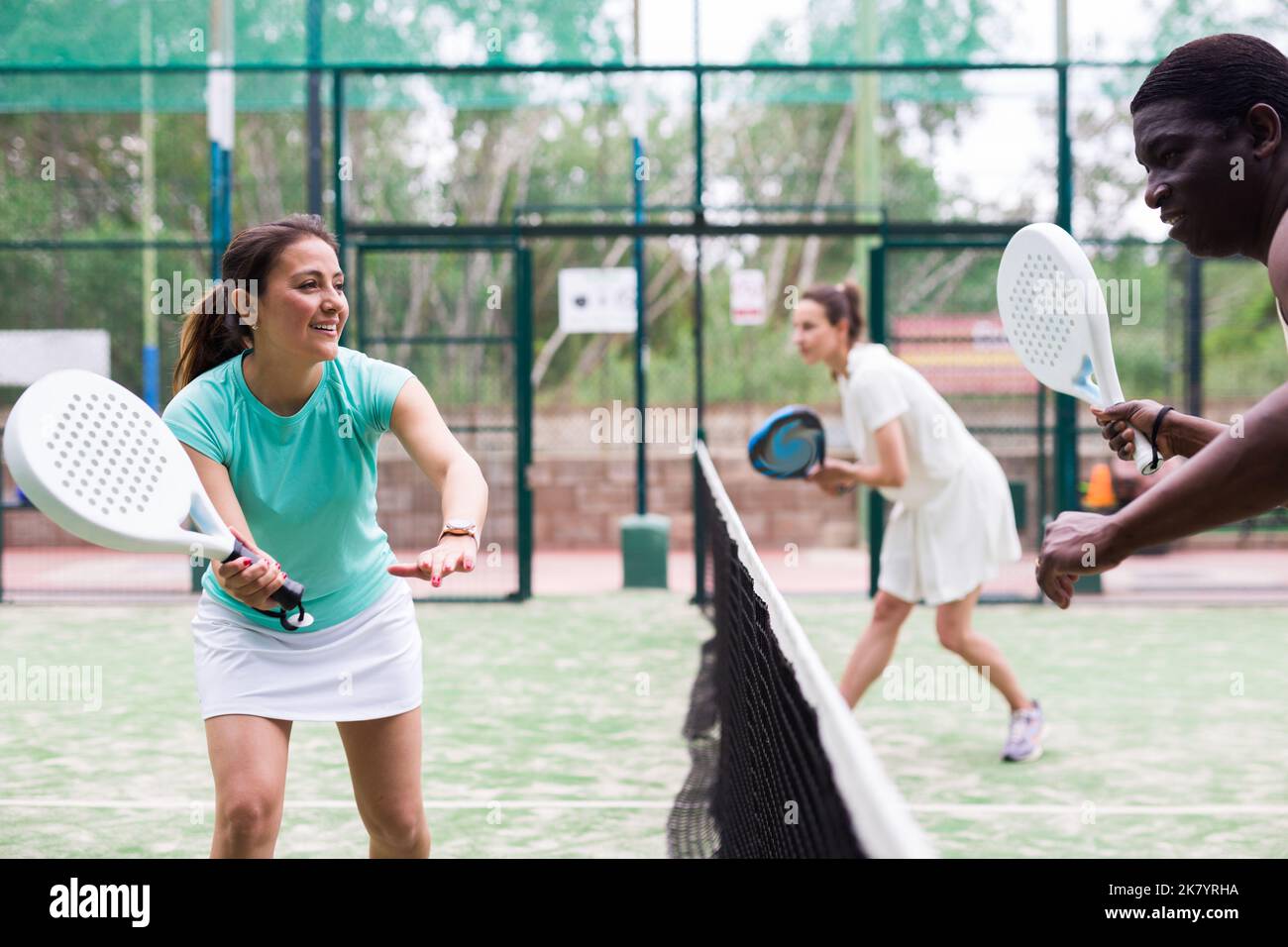 Young sporty people playing paddle tennis outdoors Stock Photo - Alamy