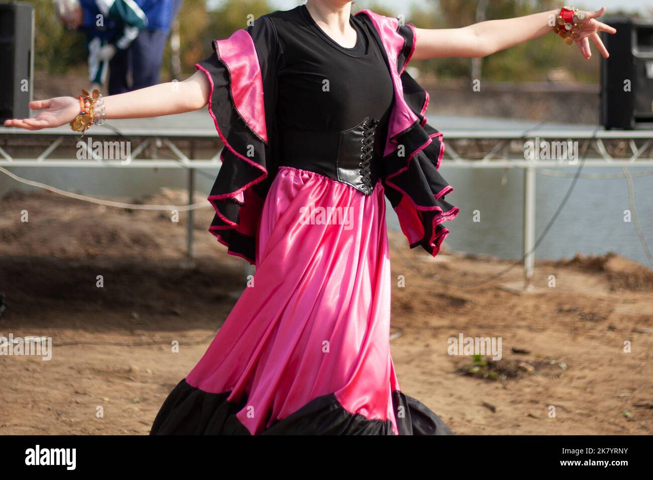 Gypsy dances in bright dresses. Girls dance on street Spanish dance ...