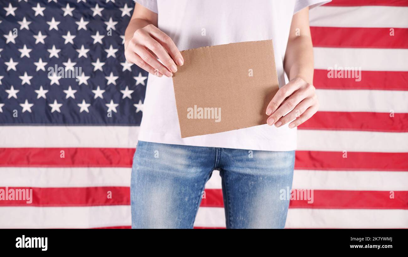 Unrecognizable woman showing empty cardboard banner. Hands holding ...